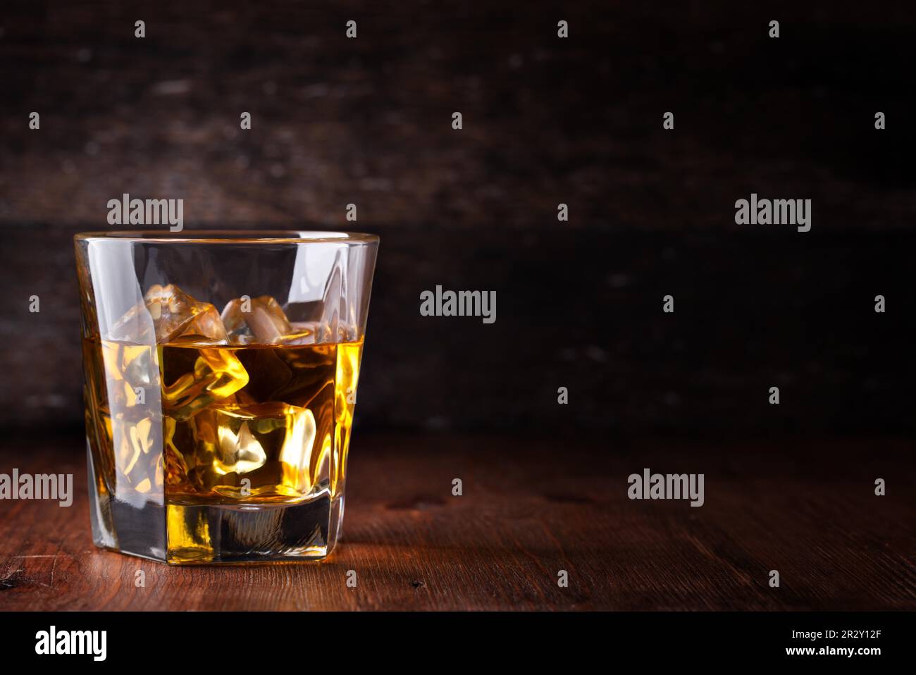 Glass of scotch whiskey and ice Stock Photo - Alamy