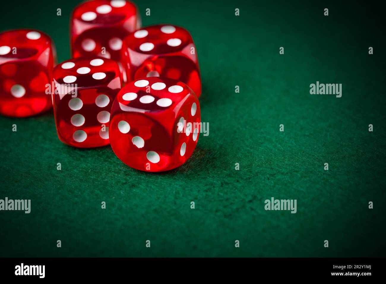 Red dice on a green felt Stock Photo - Alamy