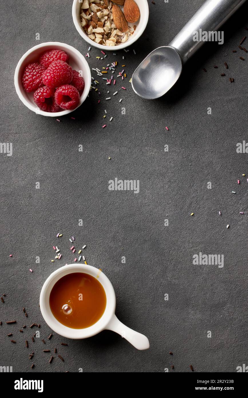 ice cream serving and decoration tools and ingredients on grey table ...