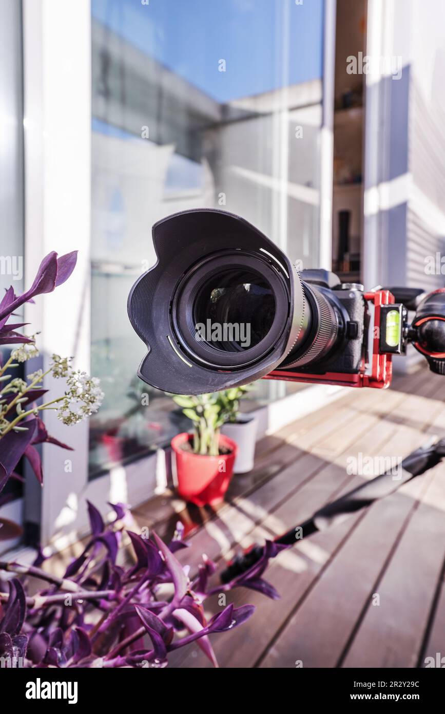 A camera mounted on a tripod with an articulated arm for shooting in ...
