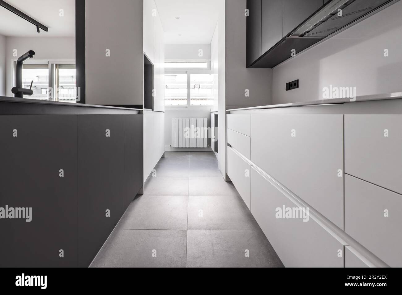 Kitchen furnished with smooth white cabinets without handles combined ...