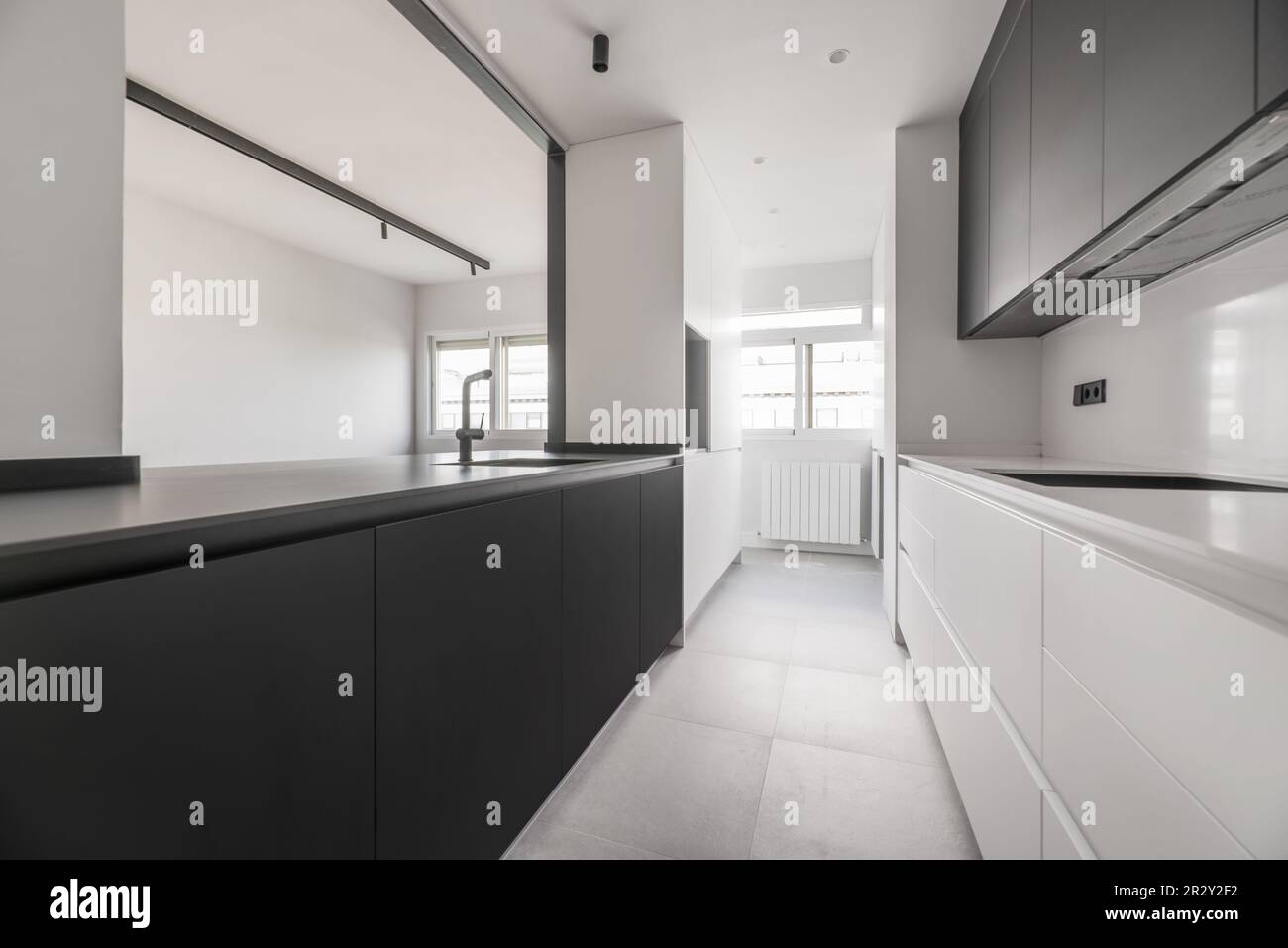 Kitchen furnished with smooth white cabinets without handles combined ...