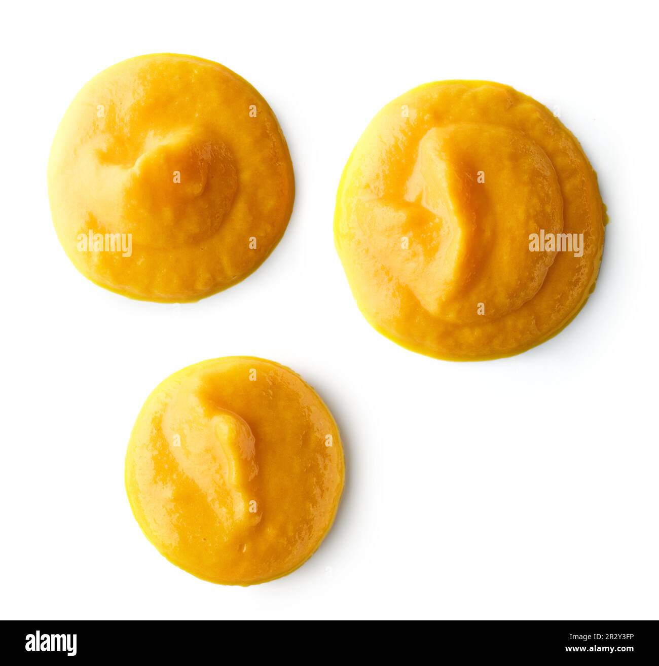 yellow vegetable puree drops isolated on white background, top view ...