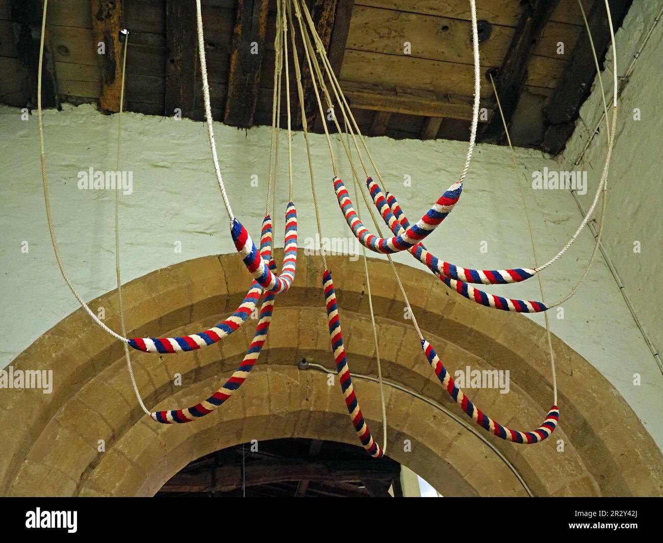 red white blue grips on bell-ringers ropes fastened out of way below ...