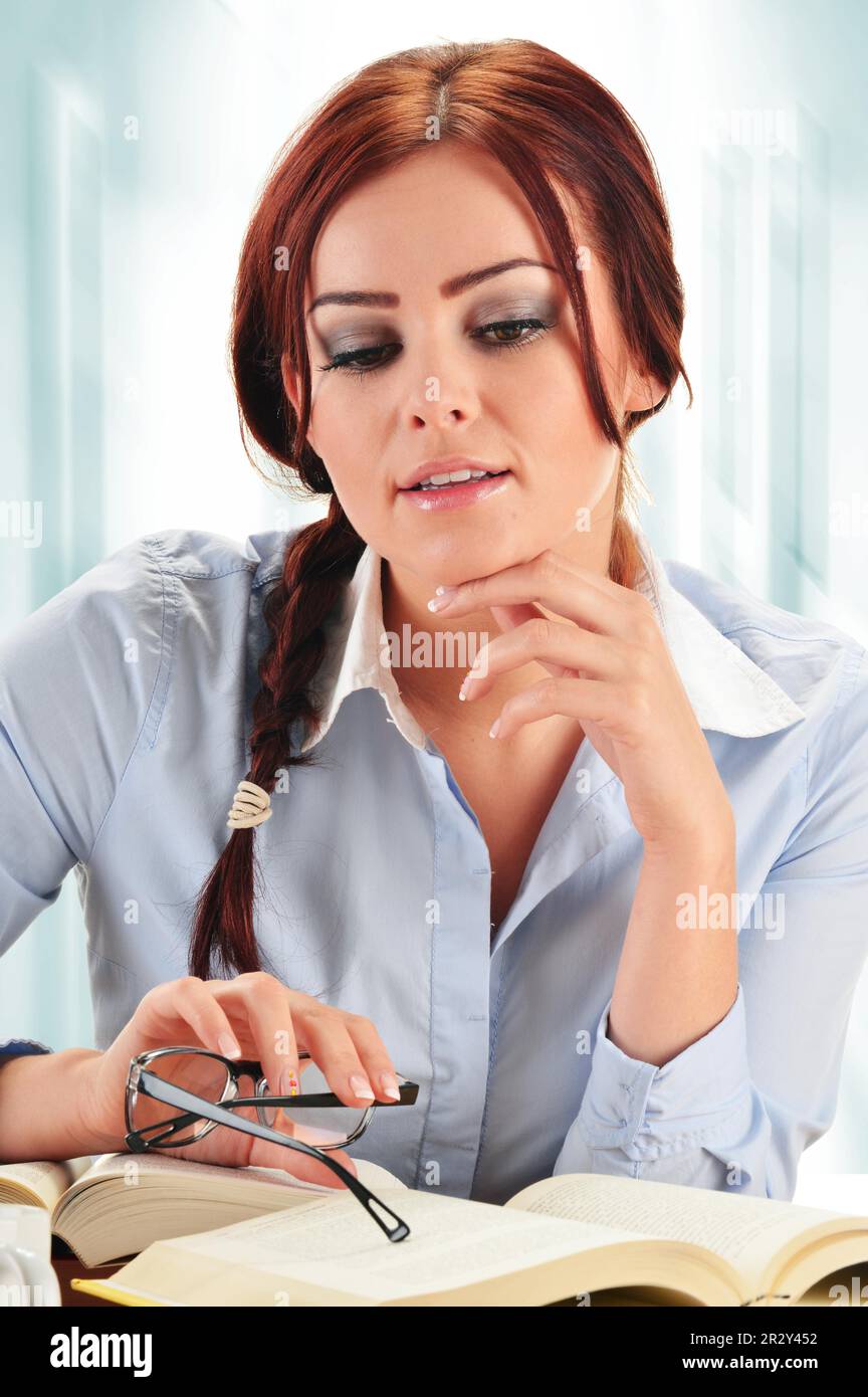 Young woman reading a book. Female student learning Stock Photo - Alamy