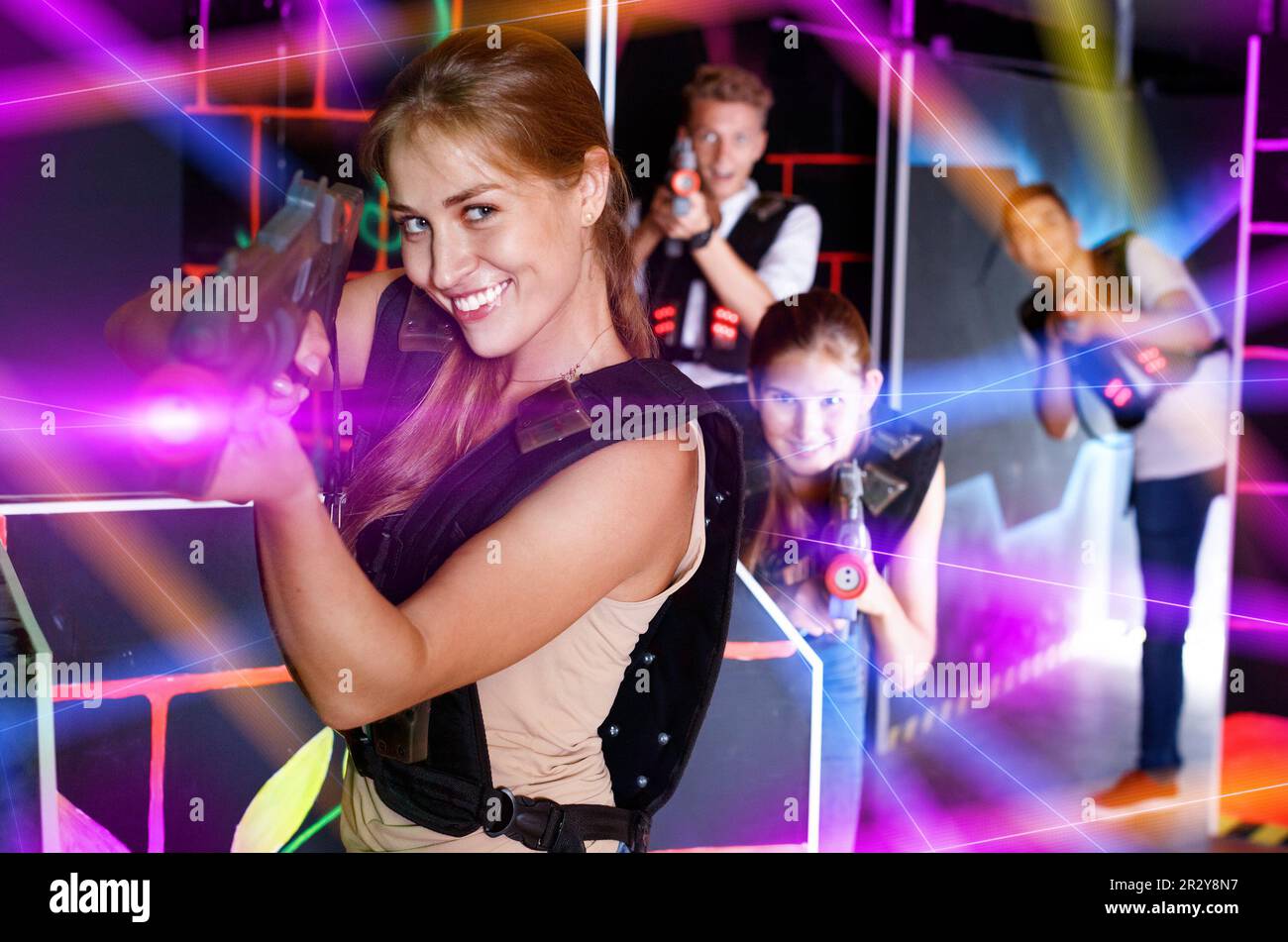 Portrait of exciting girl with laser pistol playing laser tag in Stock ...