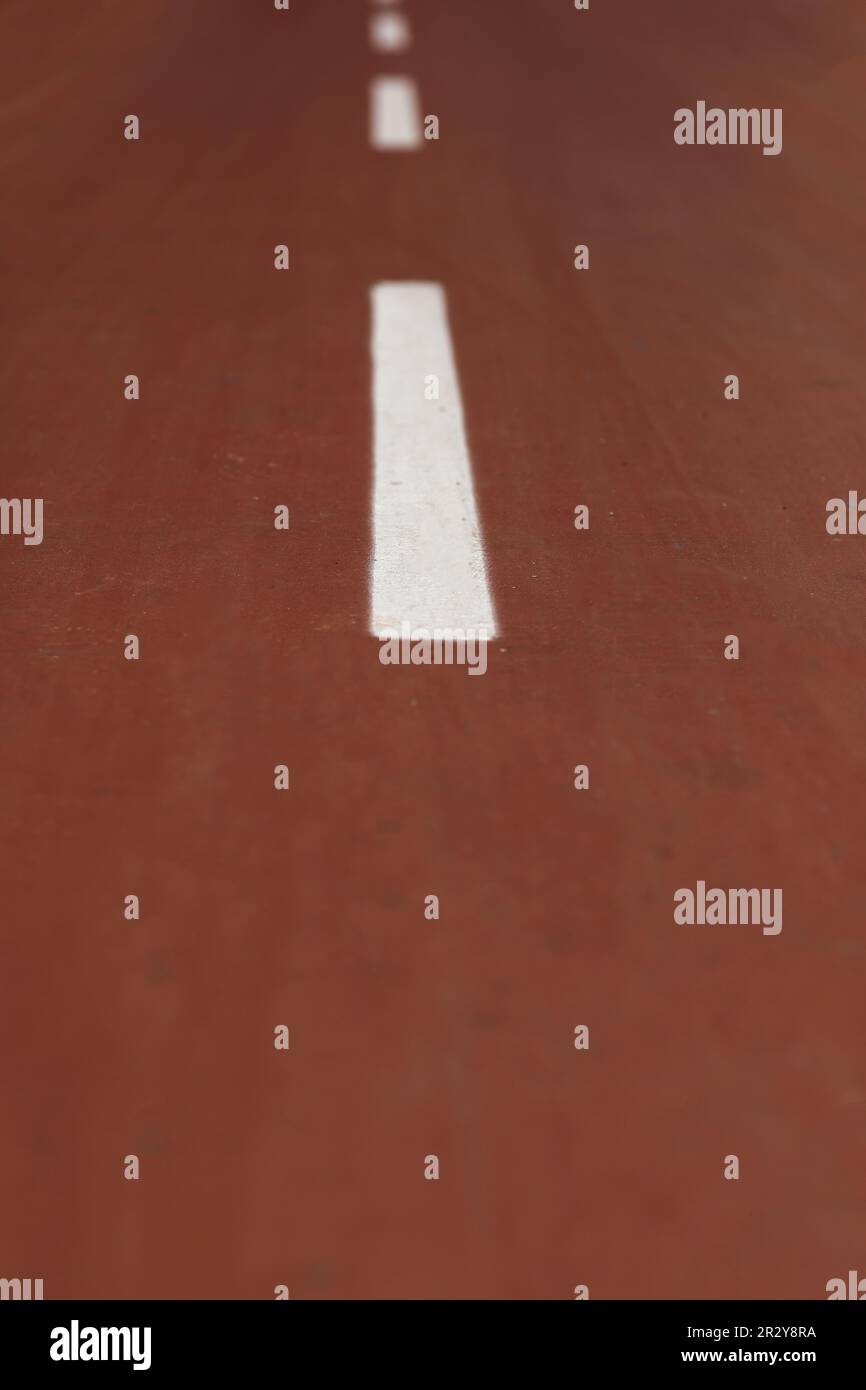 New red bikepath or pedestrian path separated by white line, traffic ...