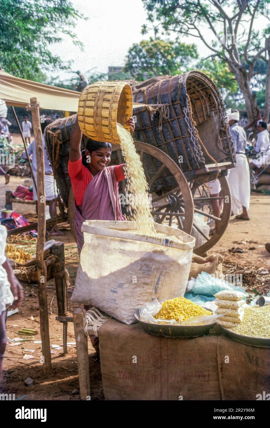 A woman winnowing Puffed popped rice, weekly periodical market at ...