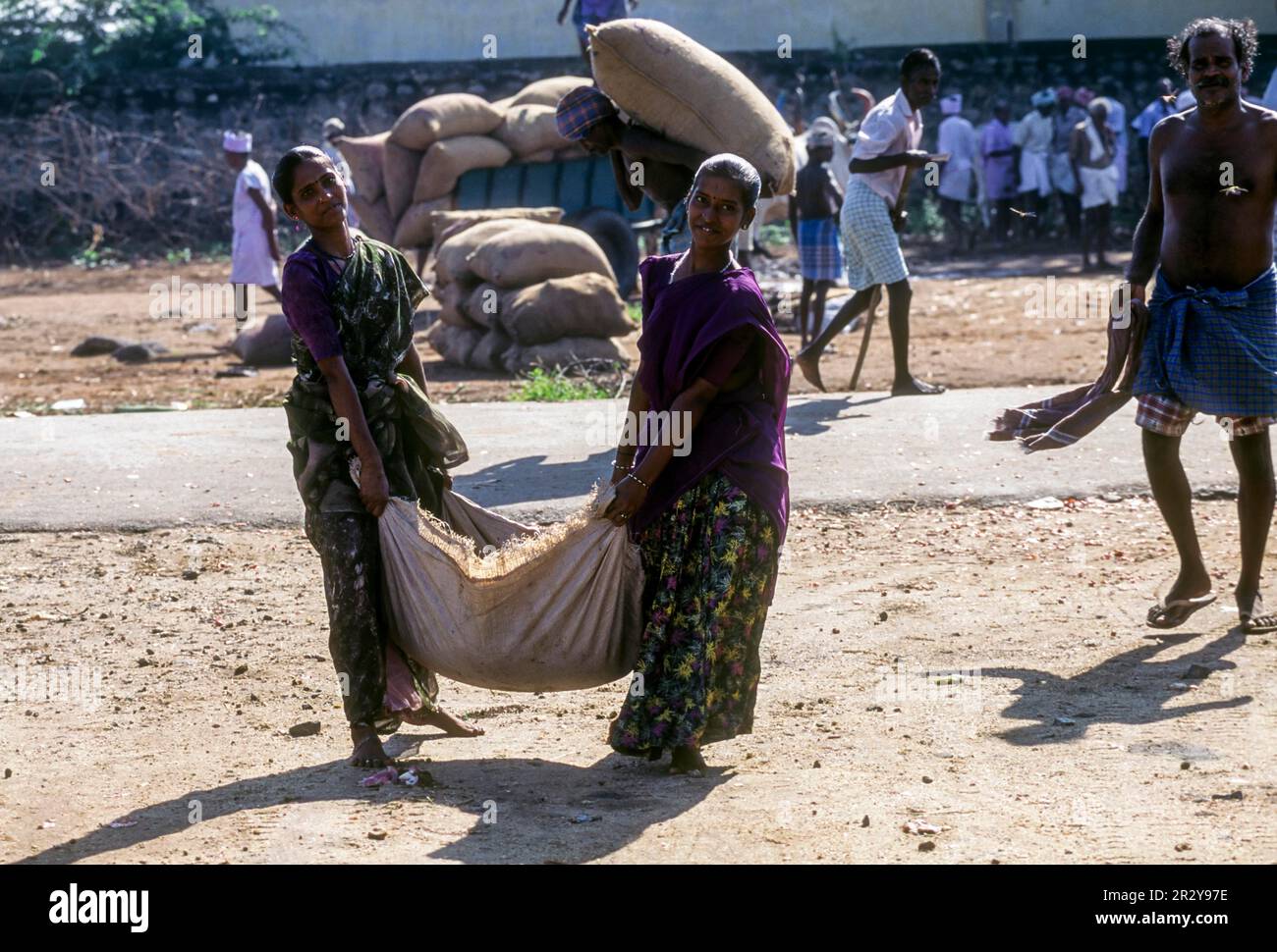 Two women carrying vegetables, weekly Periodical market at Perundurai ...