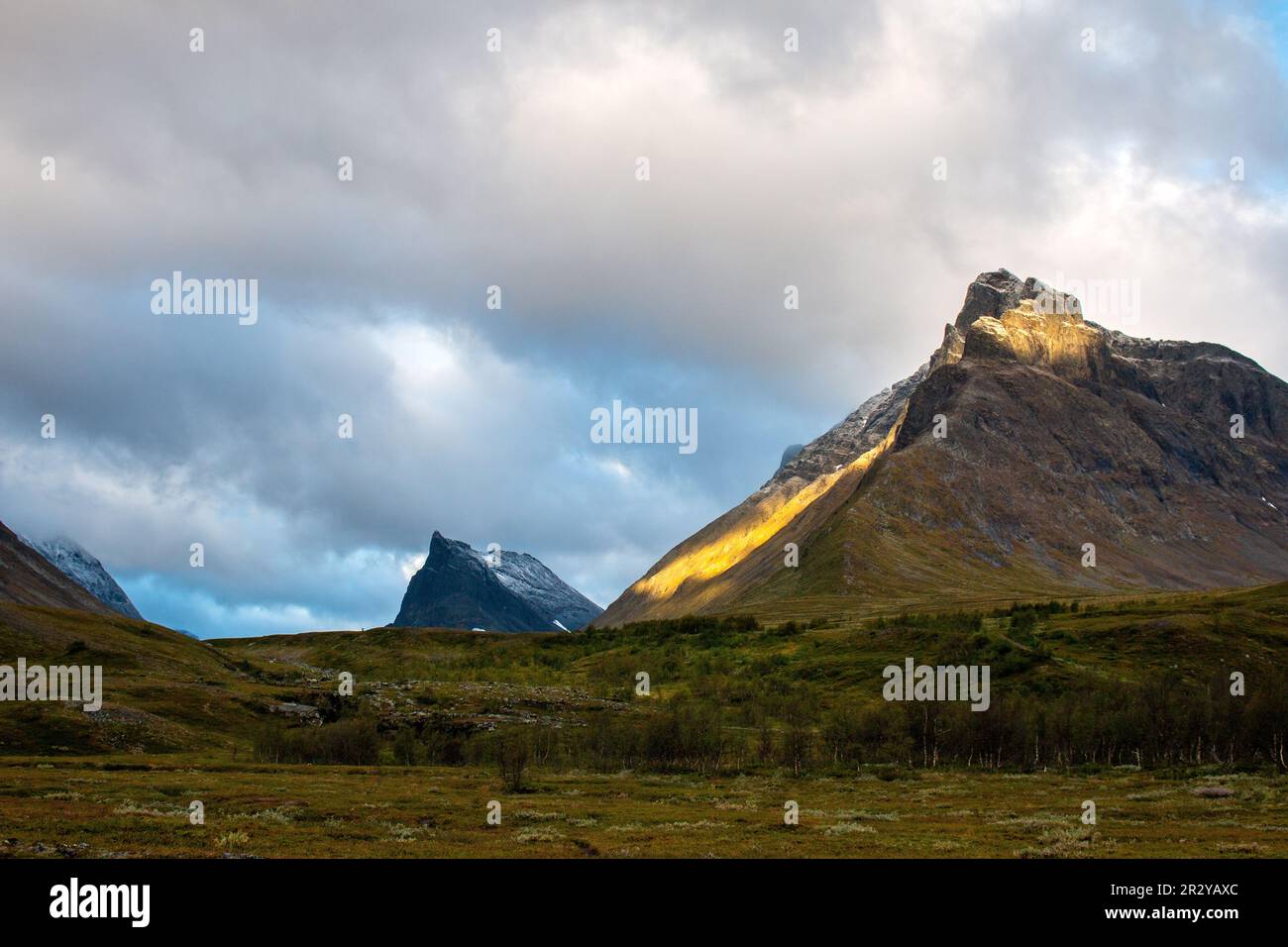 Morning sunlight on the mountainside of Nallo Massif along the hiking ...