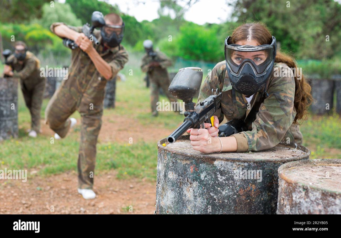 Team of friends paintball players playing together in battle Stock ...