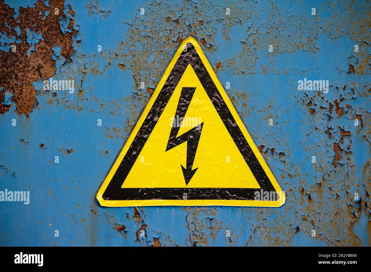 High voltage sign at a transformer substation - lightning in a yellow ...