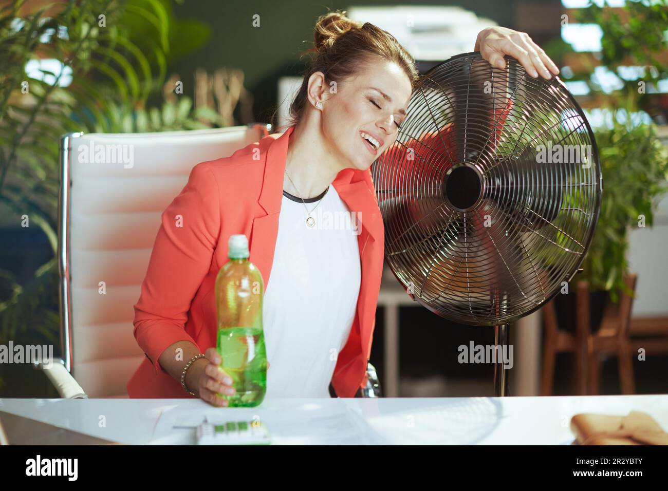 Sustainable workplace. smiling modern business woman at work in red ...