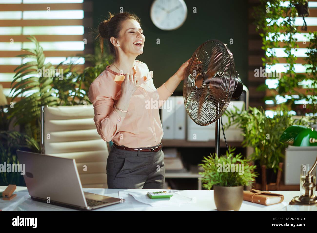 Sustainable workplace. happy modern 40 years old accountant woman in modern green office with ...