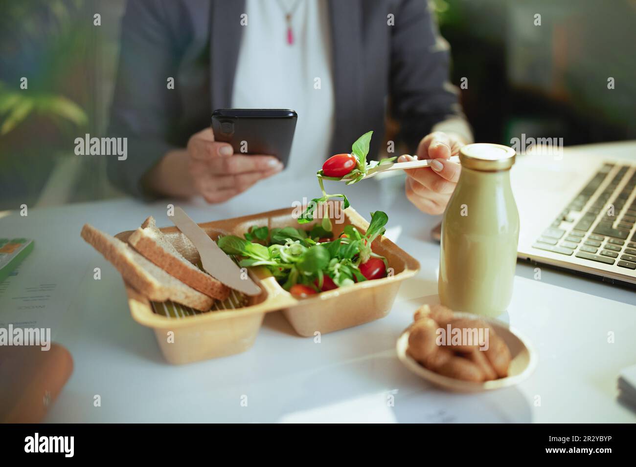Sustainable workplace. Closeup on woman employee in green office with ...