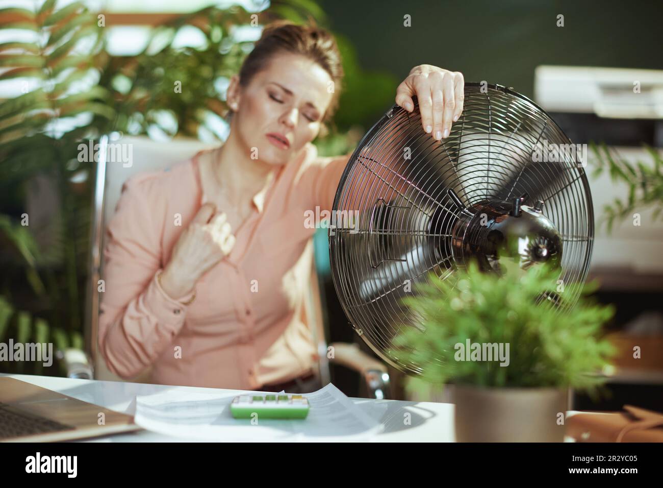 Sustainable workplace. modern 40 years old woman worker in modern green ...