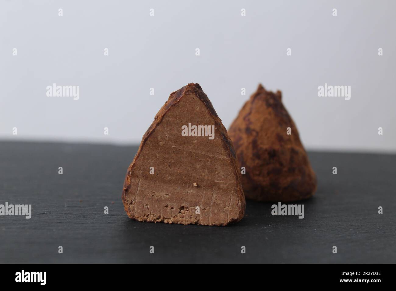 chocolate truffle candy pyramid cone triangle handmade on a gray black ...