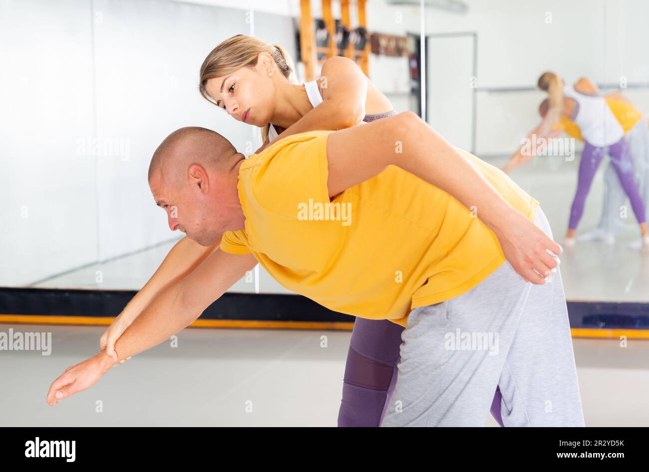 Woman practicing basic self defense movements with male partner Stock ...