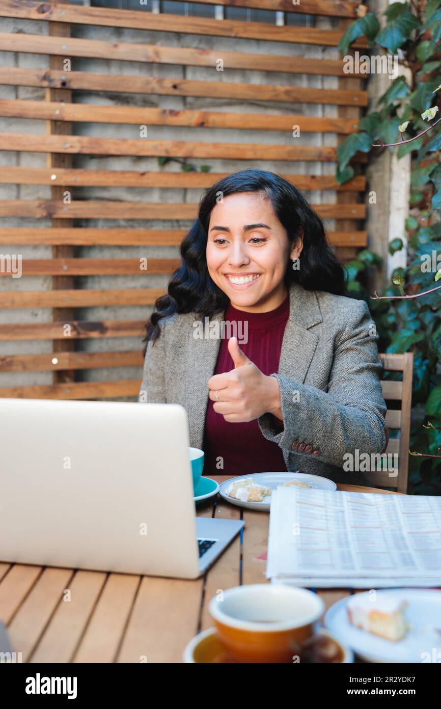 Working Remotely in Style: Young, Smiling Brunette Latina Professional ...