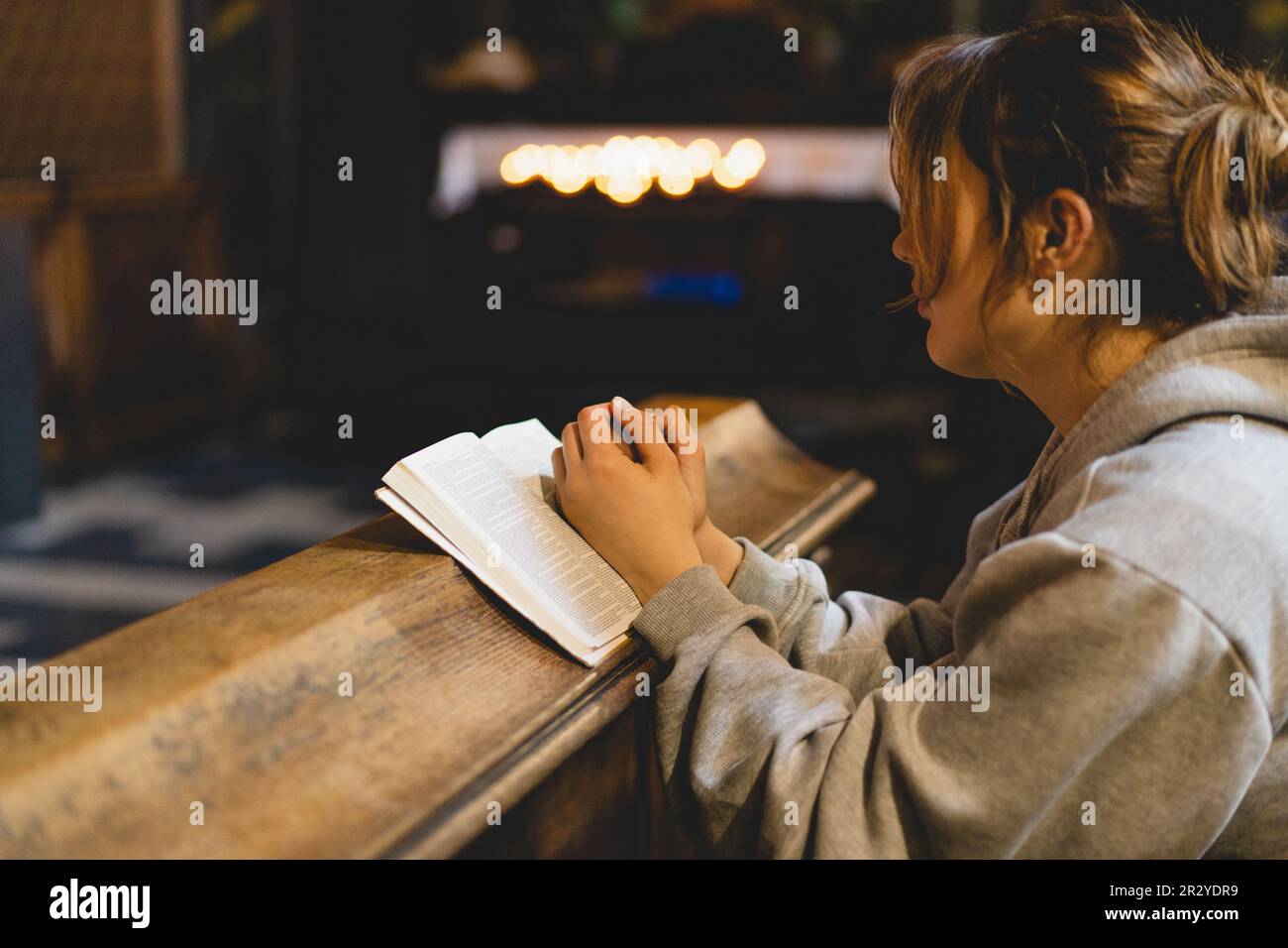 Christian woman reading bible in an ancient Catholic temple. Reading ...