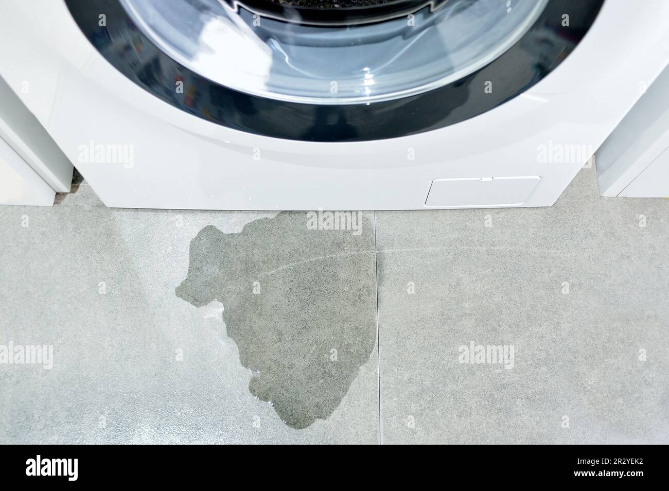 High angle image of a washing machine with drain pipe leaking water ...