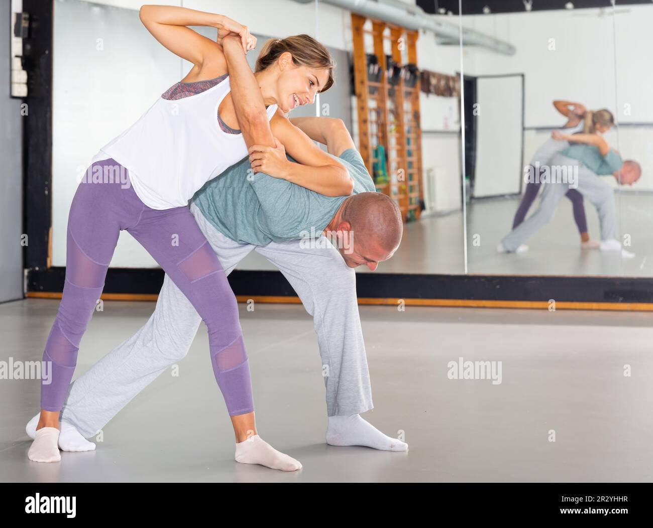 Woman practicing basic self defense movements with male partner Stock ...