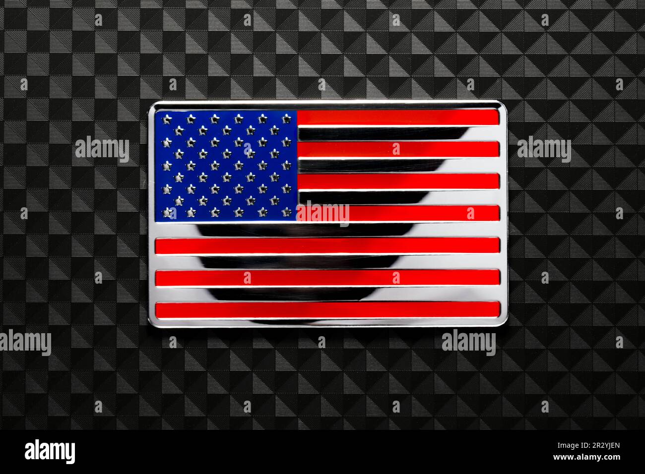 Shiny US American flag emblem on dark carbon fiber. Symbolizing USA ...