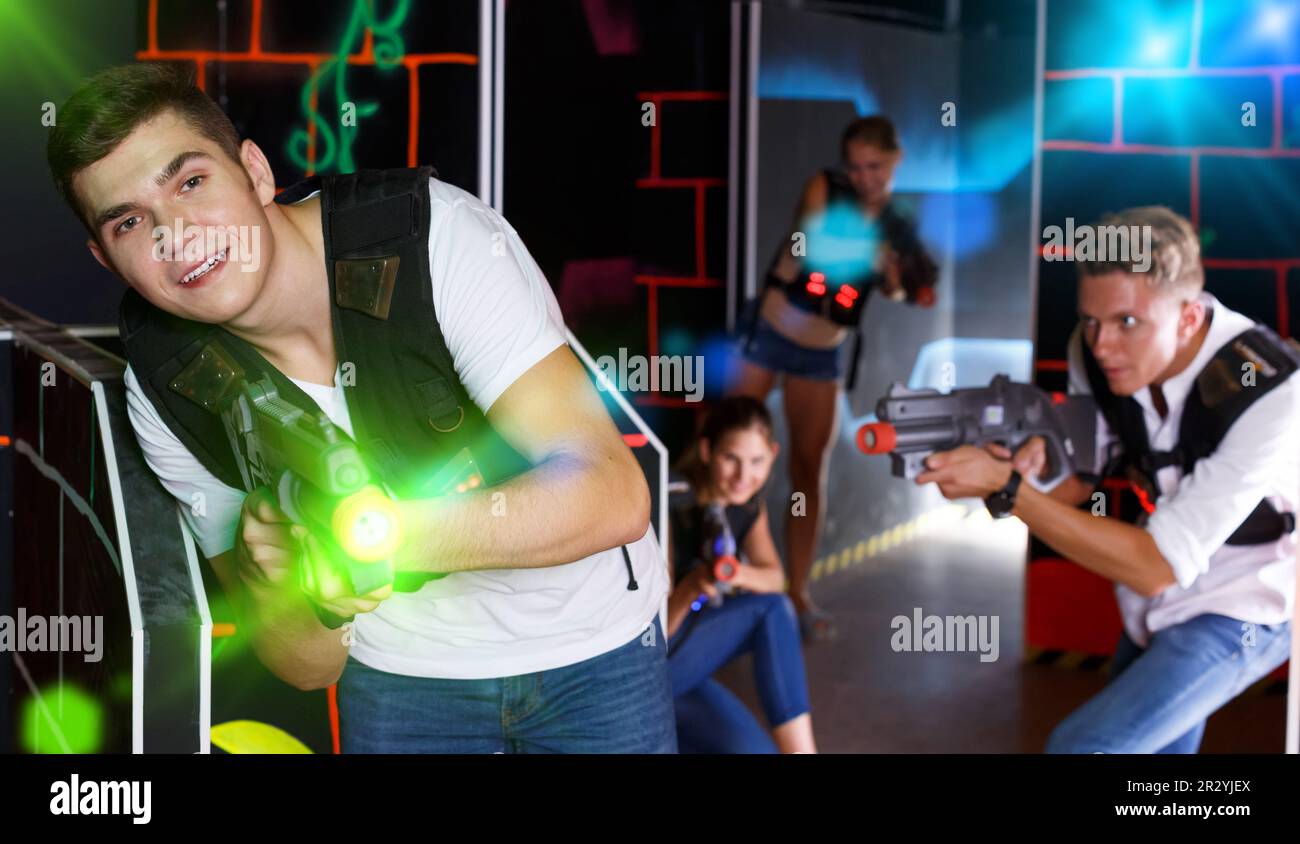 Guy with laser pistol and playing lasertag with his friends in Stock ...