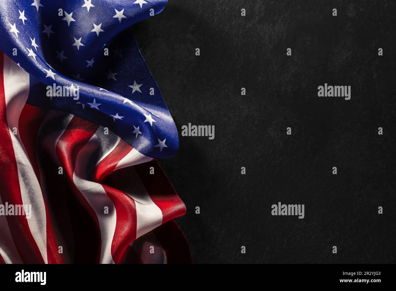Ruffled USA flag on dark black background with copyspace for text. US ...