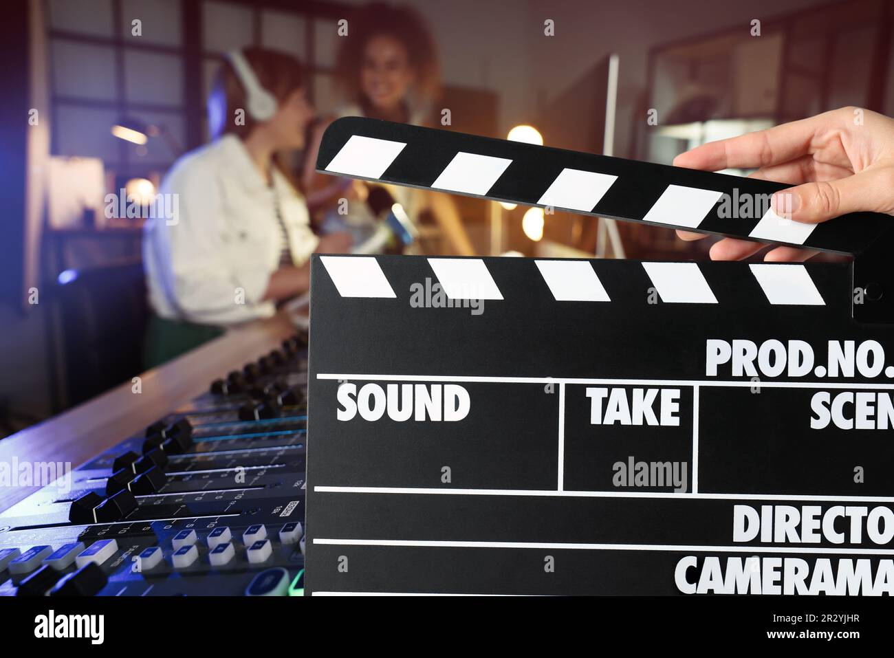 Shooting movie. Second assistant camera holding clapperboard in front ...