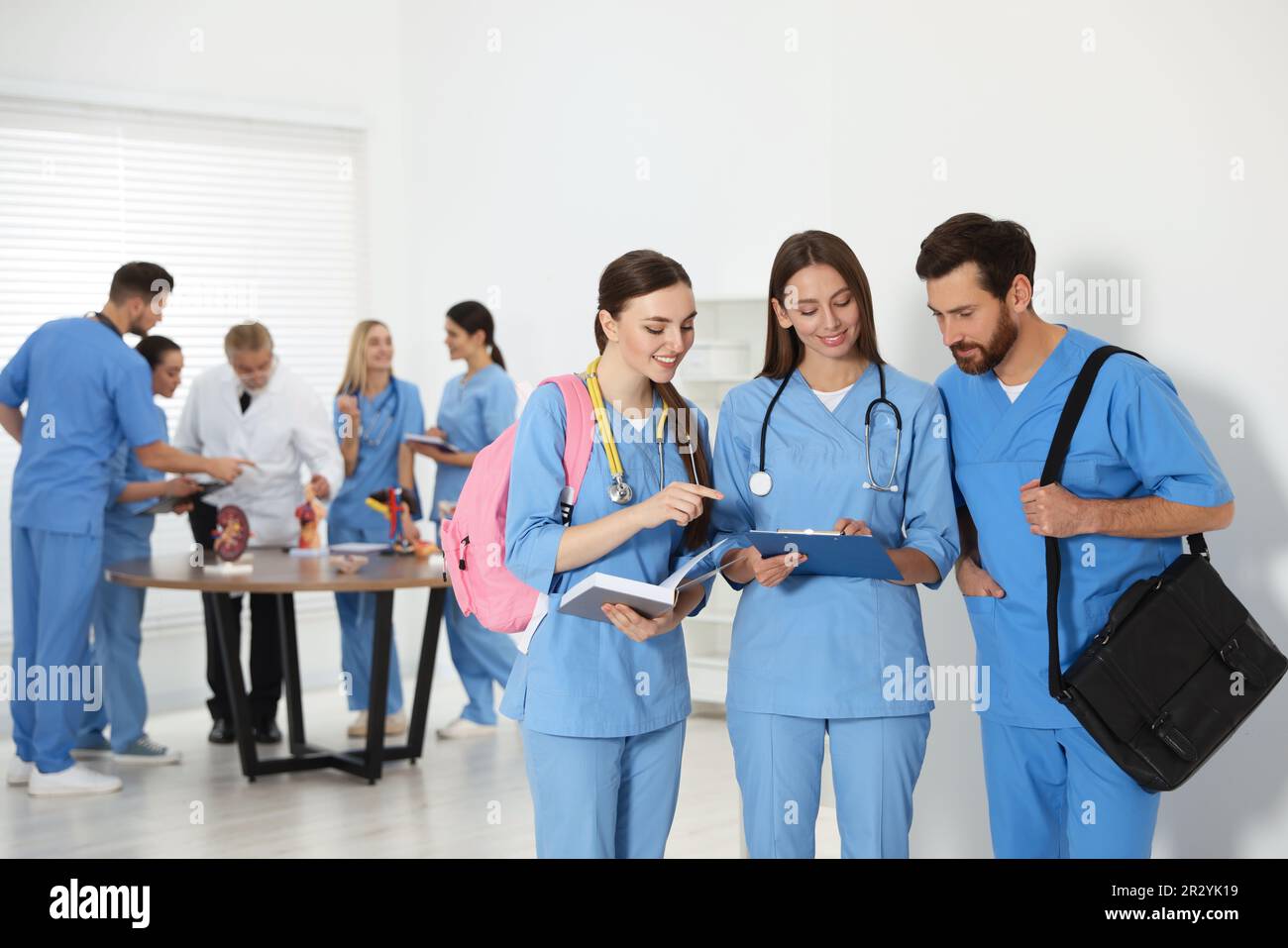 Medical students wearing uniforms in university hallway Stock Photo - Alamy