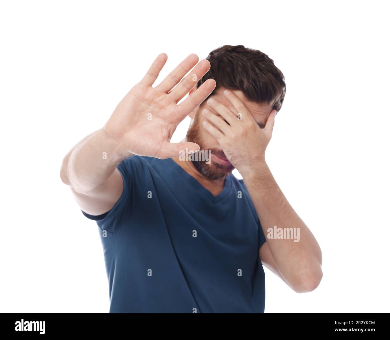 Embarrassed man covering face with hand on white background Stock Photo ...