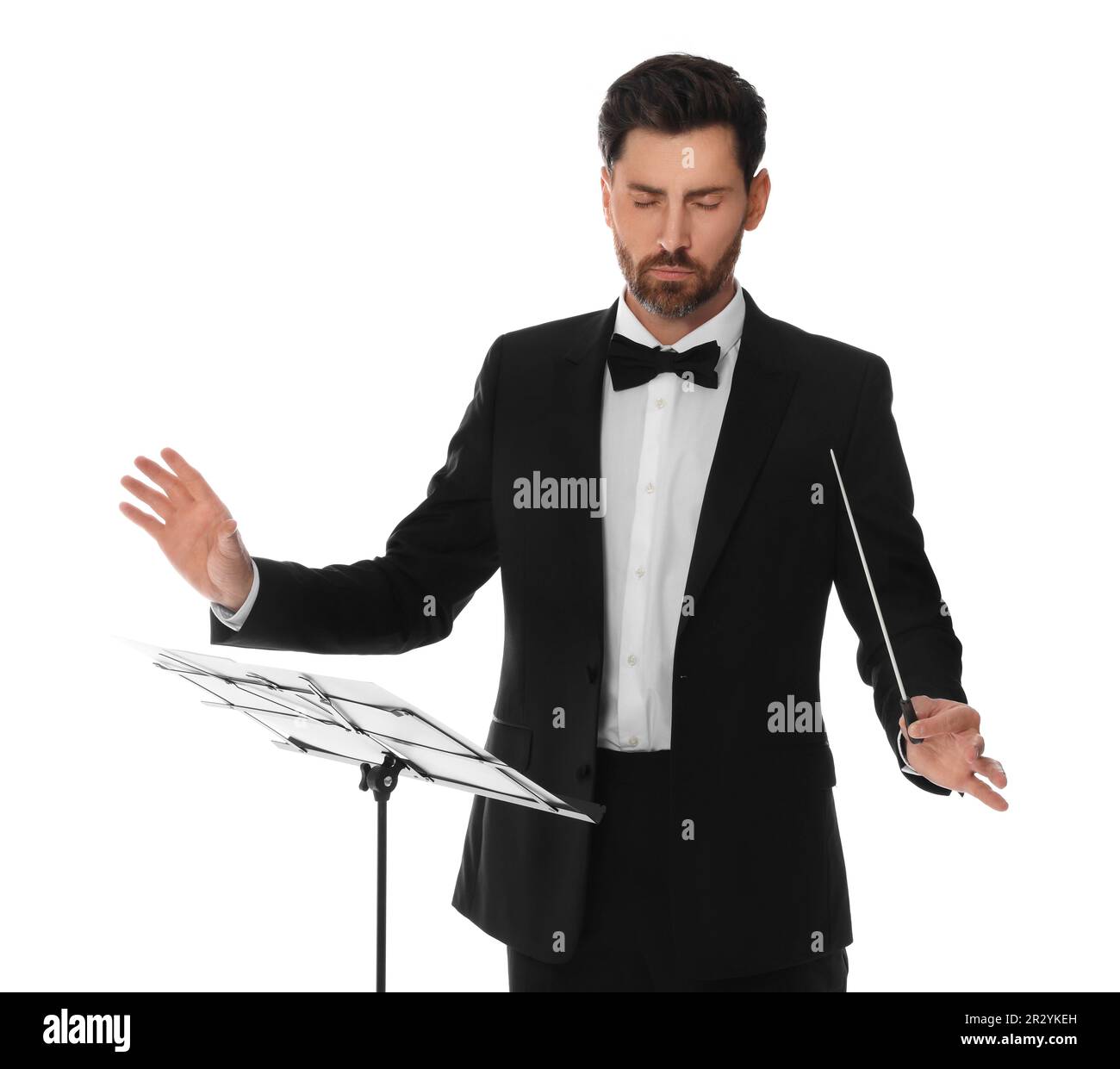 Professional conductor with baton and note stand on white background ...