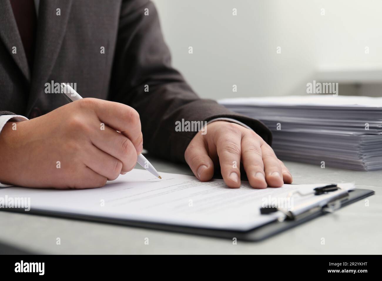 Man signing document at table in office, closeup Stock Photo - Alamy