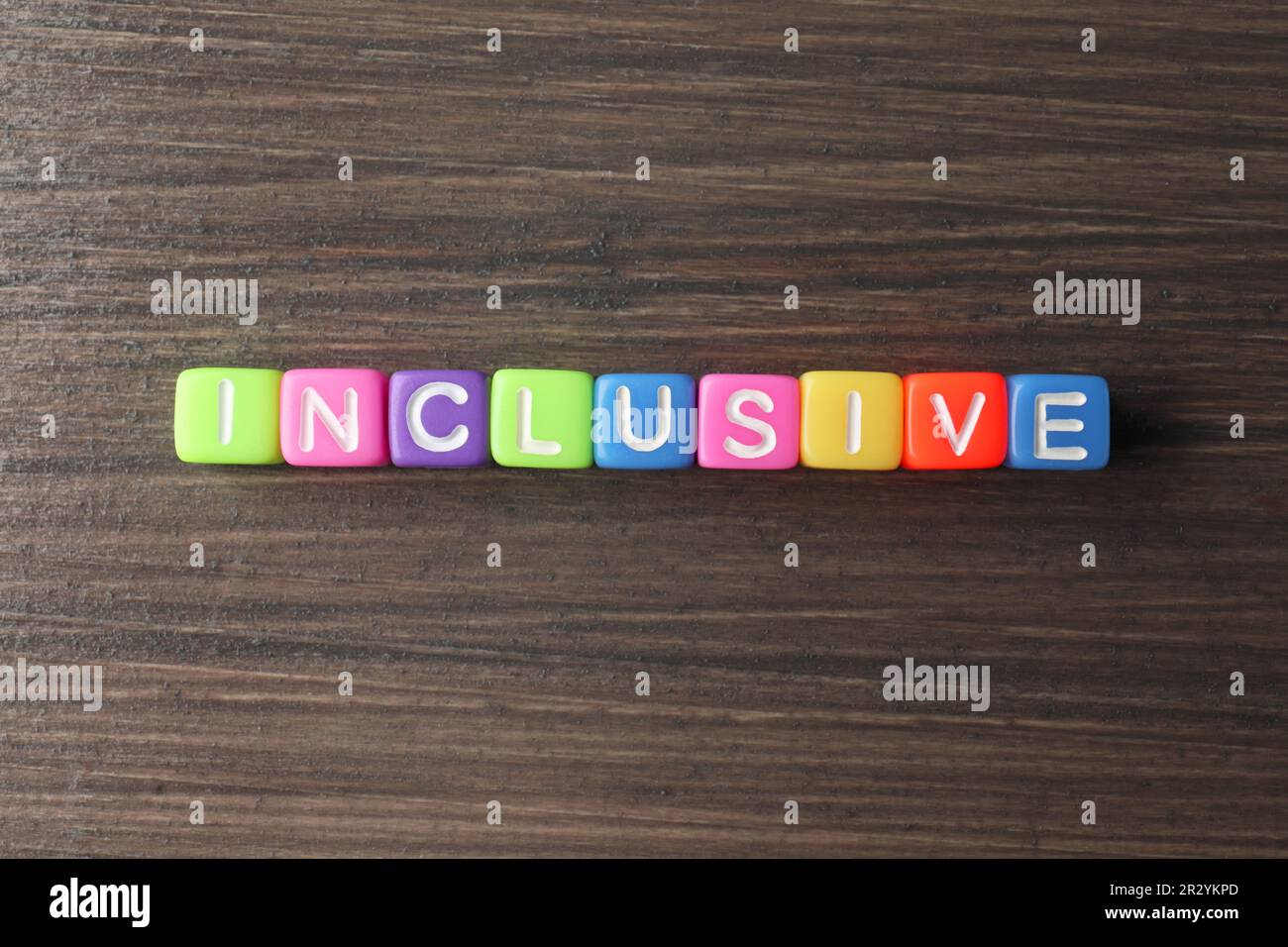 Colorful cubes with word Inclusive on wooden table, flat lay Stock ...