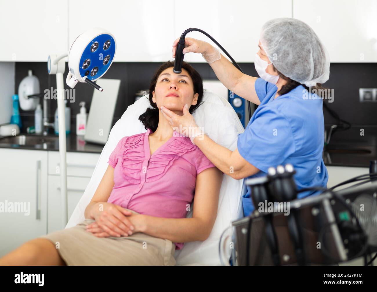 Asian female client getting face skin rf lifting procedure Stock Photo ...