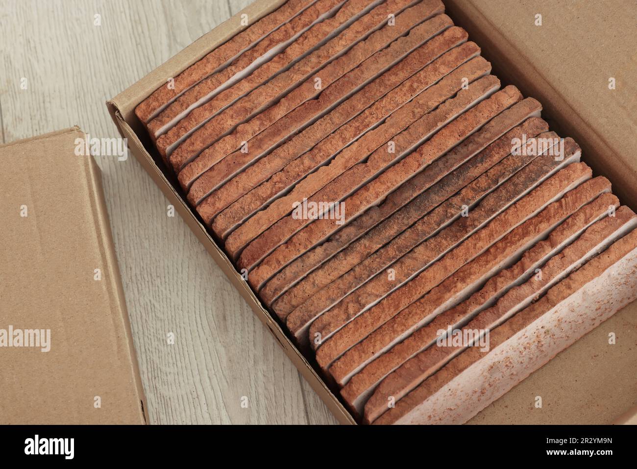 Box with decorative bricks on floor. Tiles installation process Stock ...