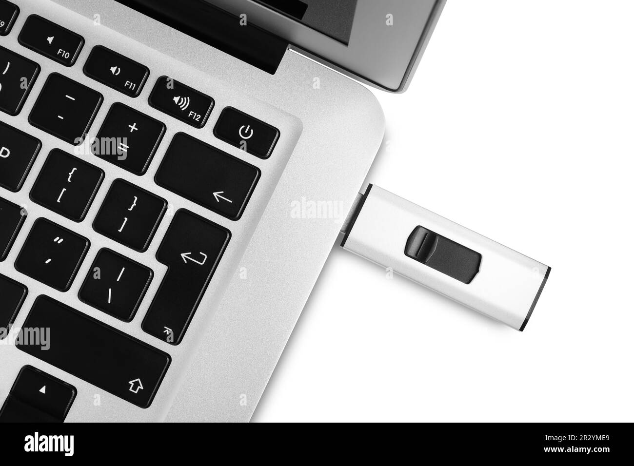 Modern usb flash drive attached into laptop on white background, top ...