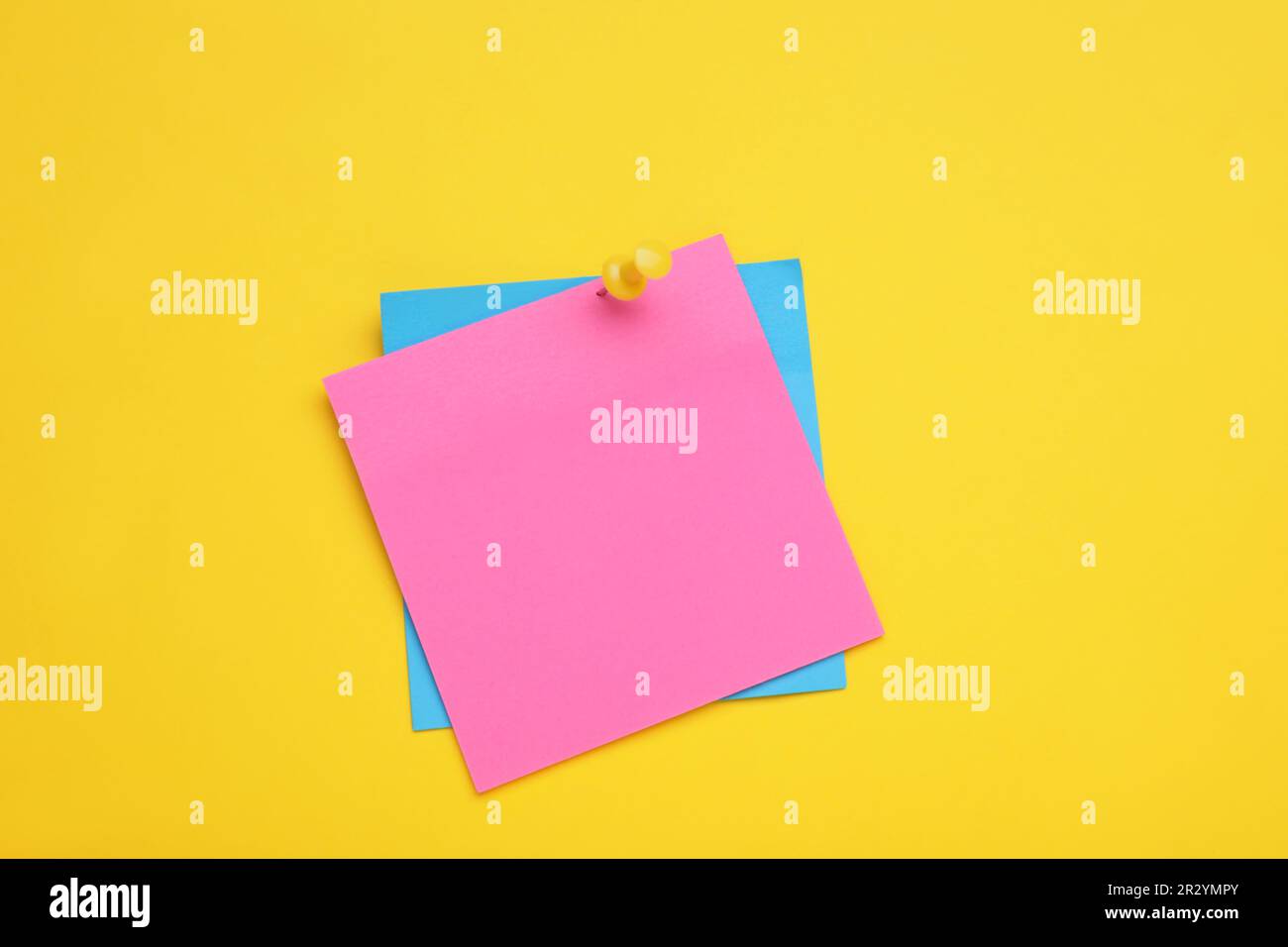 Paper notes on yellow background, top view Stock Photo - Alamy