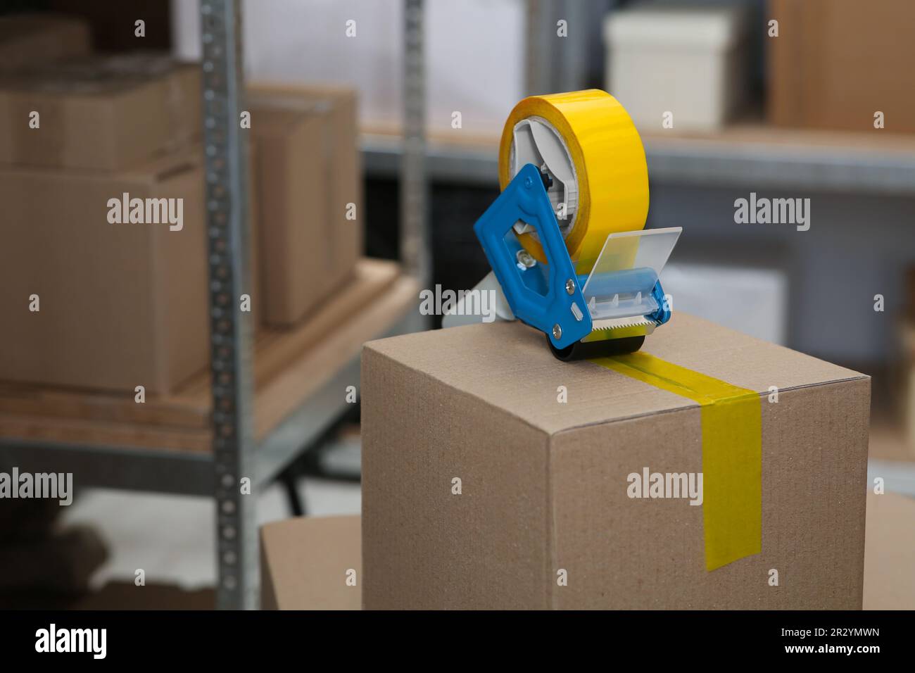 Taping box with adhesive tape dispenser indoors. Space for text Stock ...