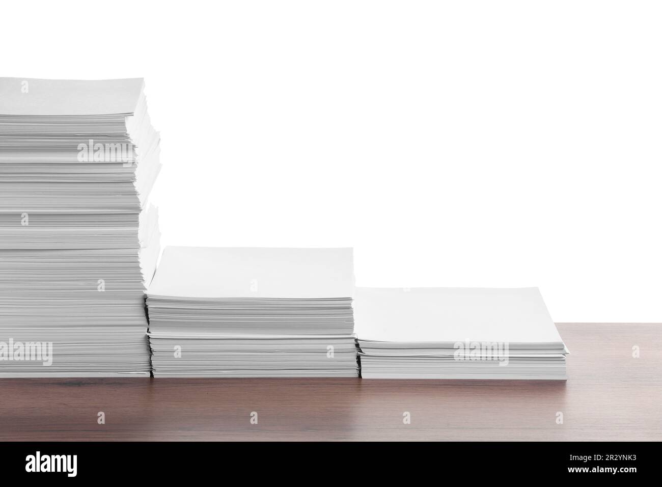 Stacks of paper sheets on wooden table against white background Stock ...