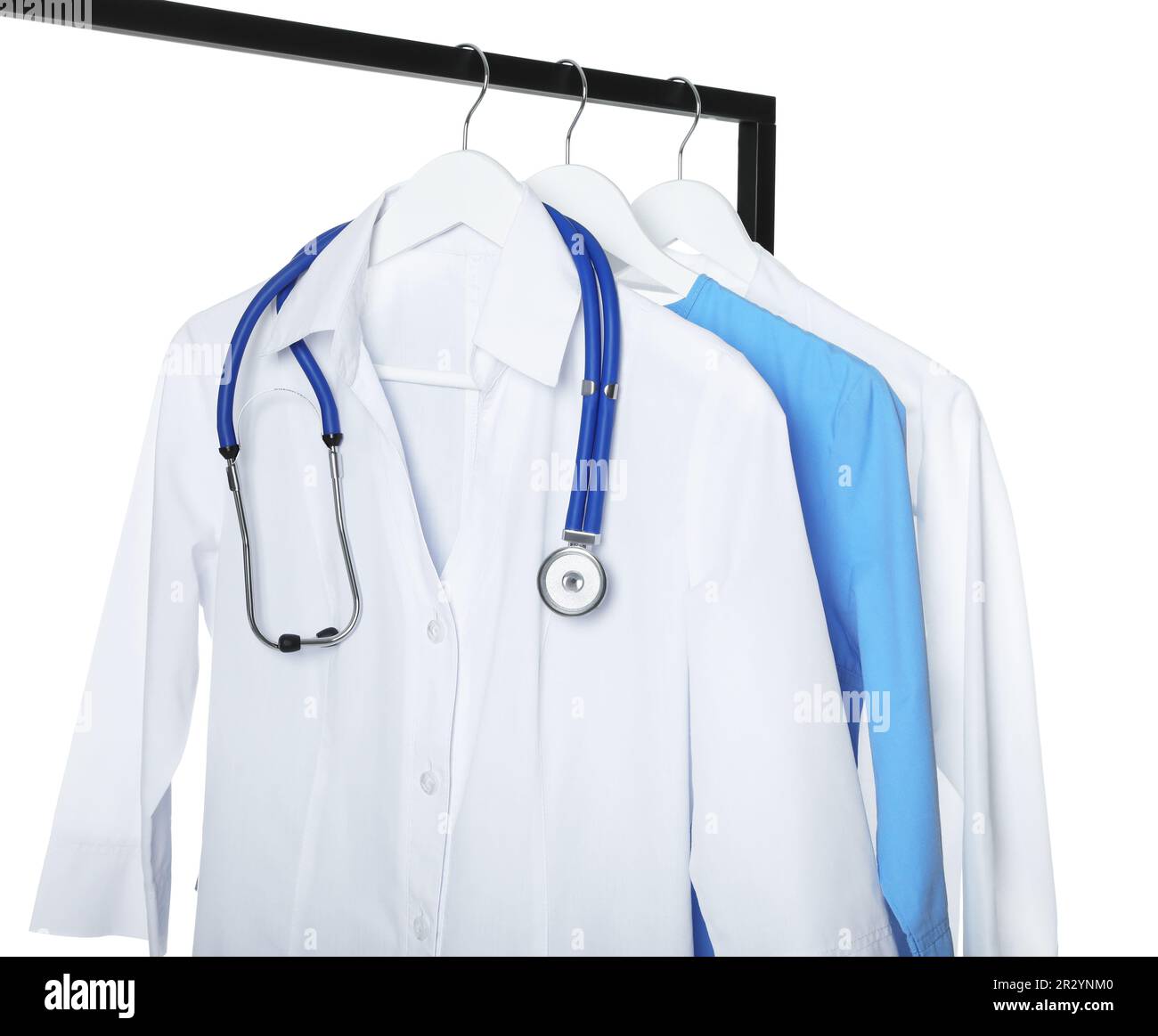 Doctor's gown with stethoscope and different medical uniforms on rack ...