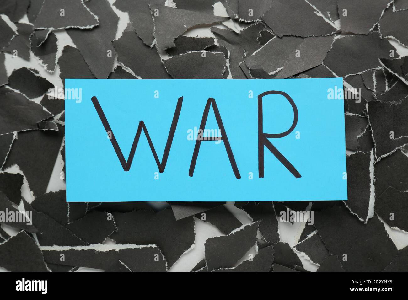 Word War and pieces of torn black paper on white background, flat lay ...