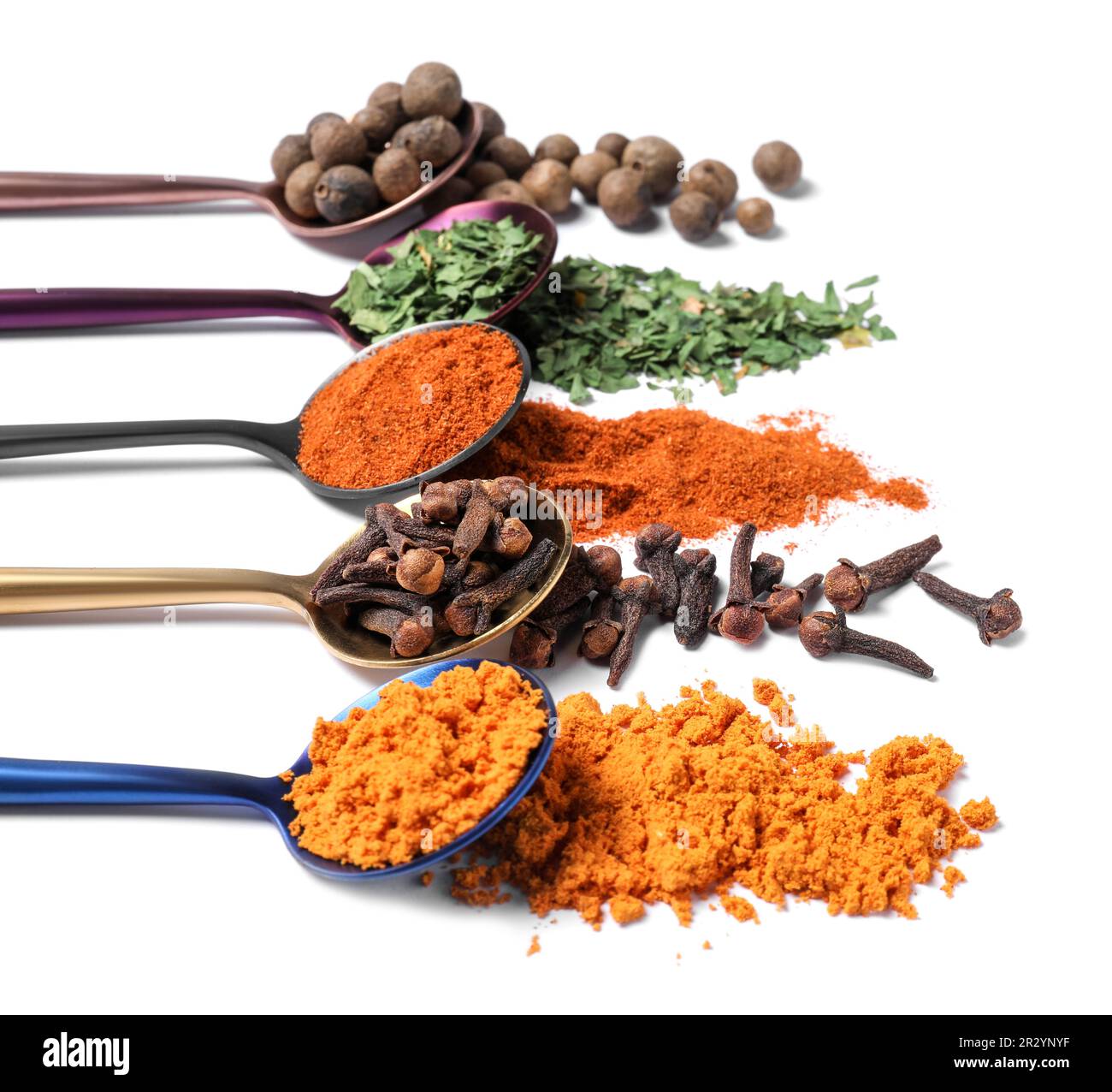 Metal spoons with different spices on white background Stock Photo - Alamy