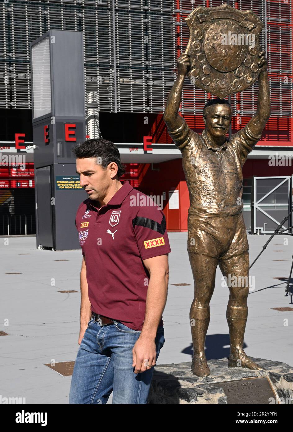 Queensland coach Billy Slater walks past the statue of Wally Lewis ...
