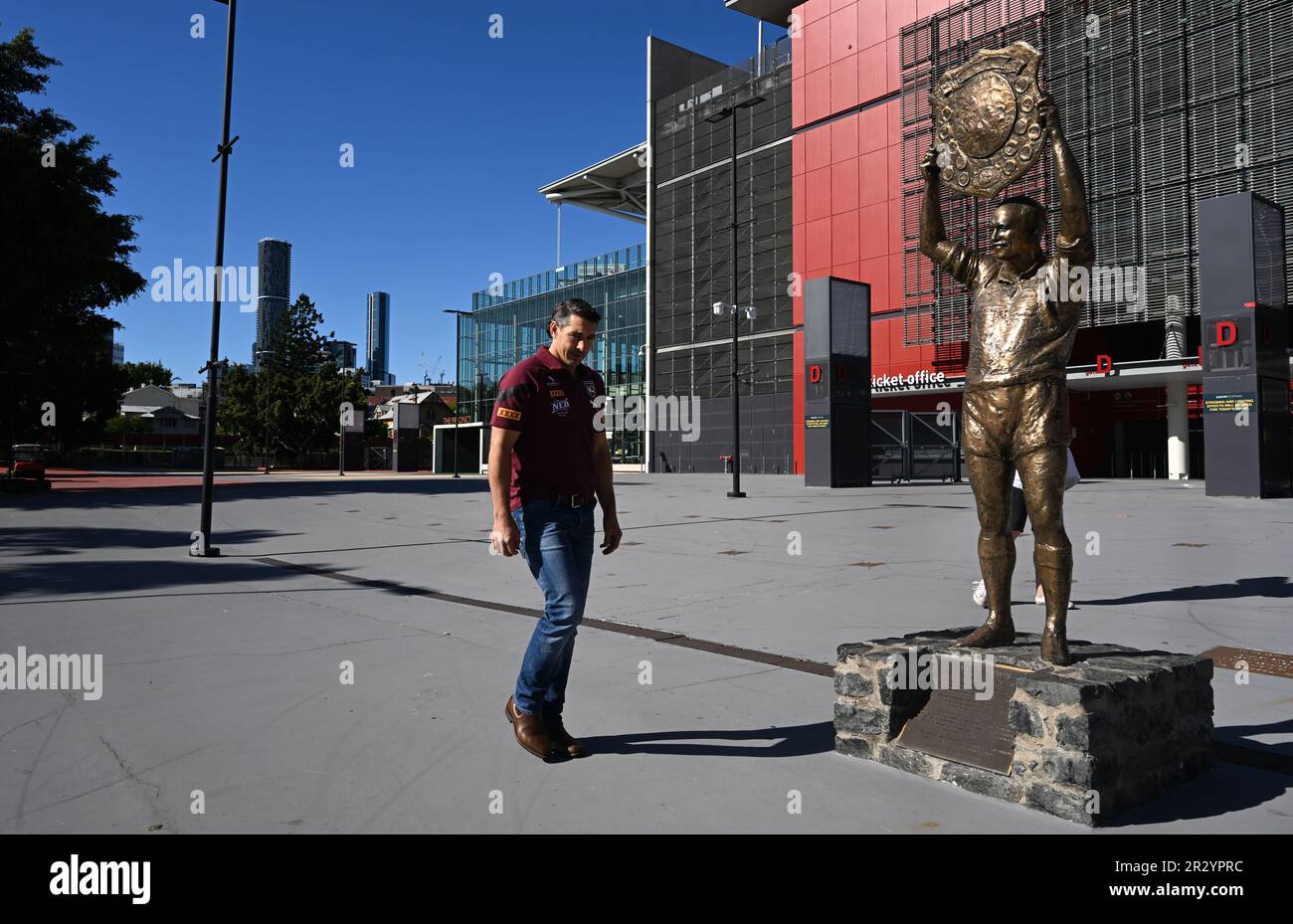 Queensland coach Billy Slater walks past the statue of Wally Lewis ...