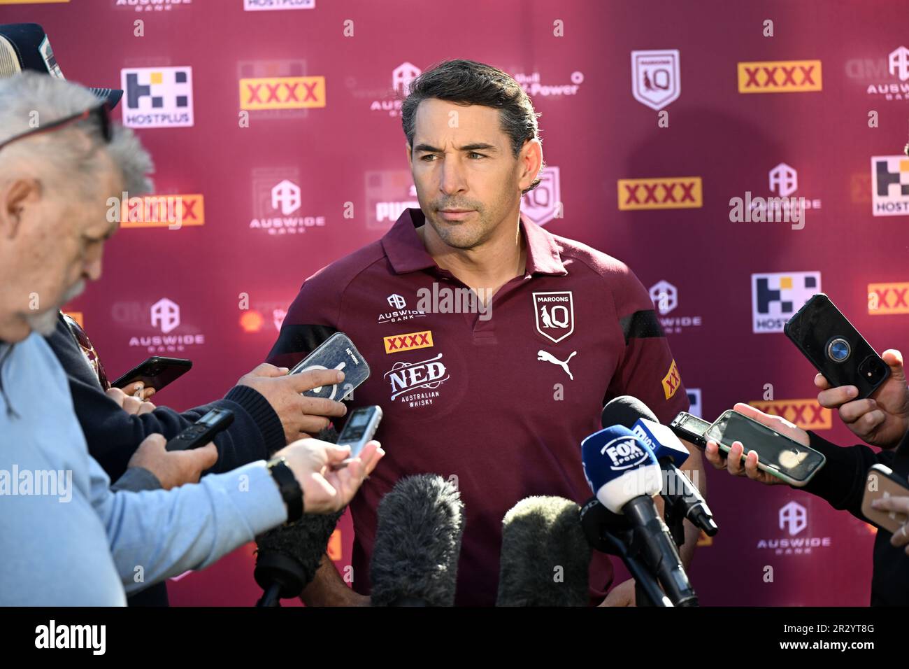 Queensland coach Billy Slater (centre) is seen at a press conference ...