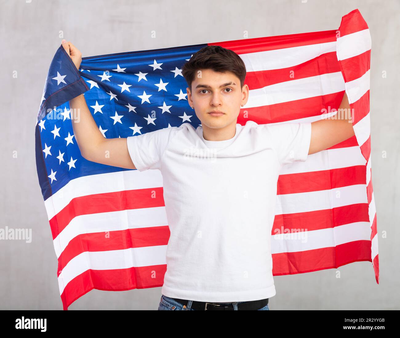 Focused young guy holding USA flag Stock Photo - Alamy