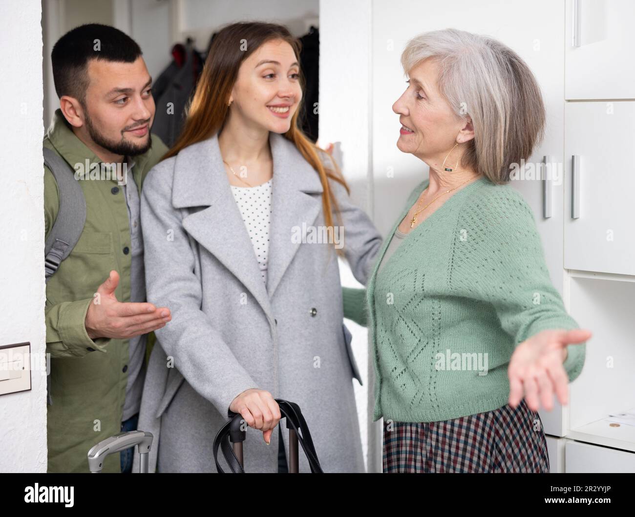 Children coming to visit their elderly mother to parental home Stock ...
