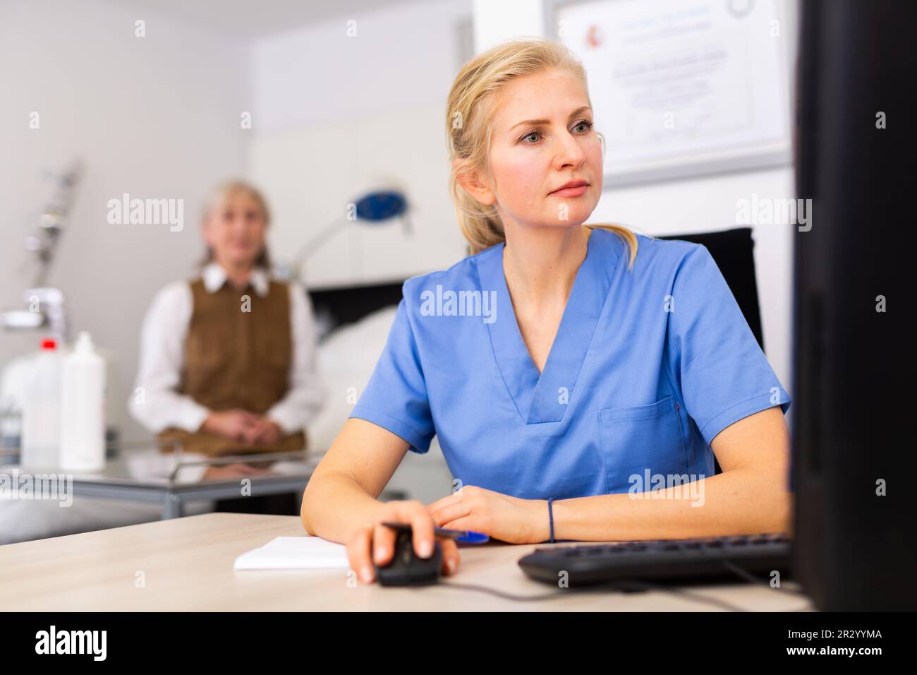 Young woman dermatologist using computer during appointment Stock Photo ...
